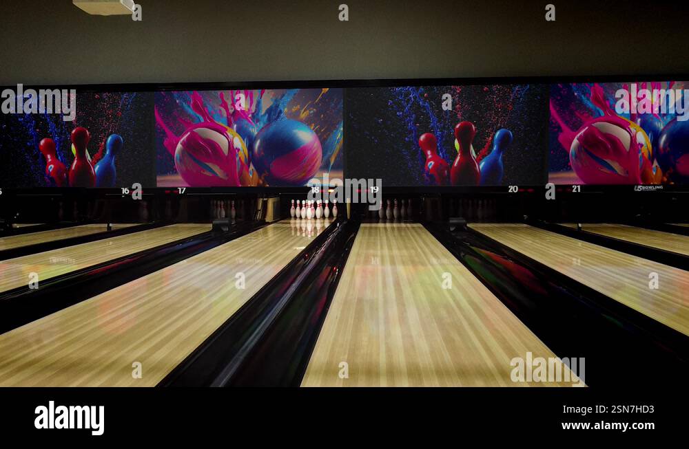 Push toward pins on bowling lane as ball comes in from the left for a ...