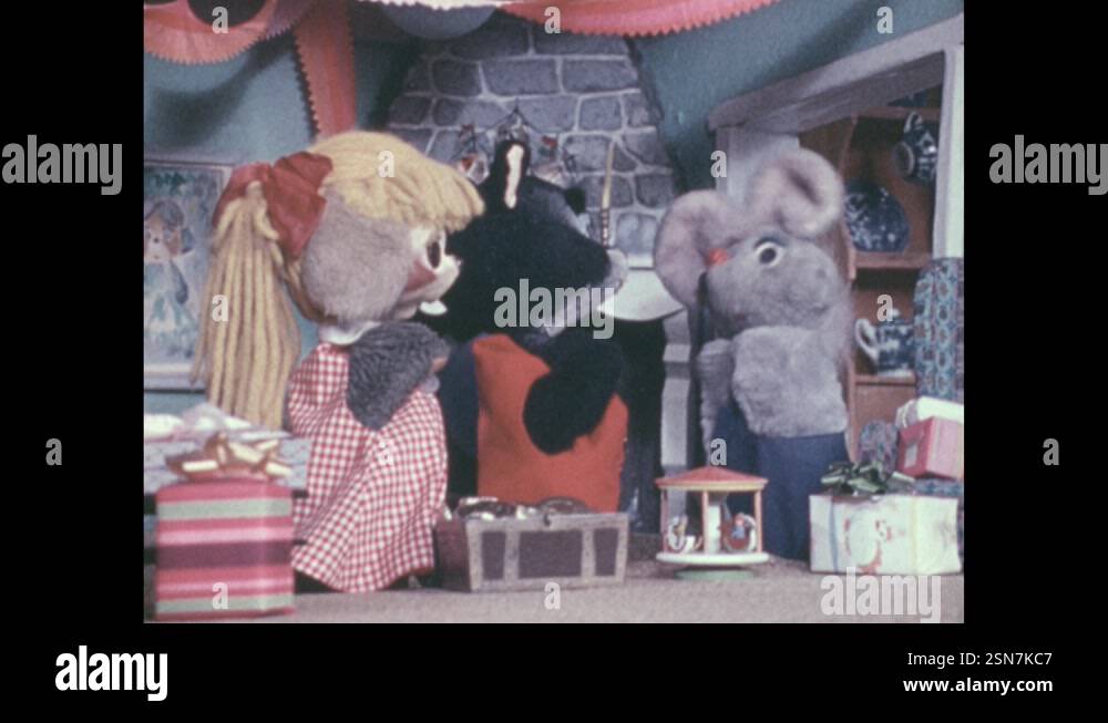 1970s: Puppetry: Group of puppets gathered inside around an opened ...