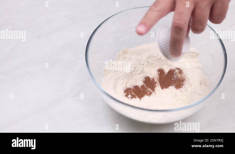 Adding the measured amount of cocoa to the flour. Making the dough for ...