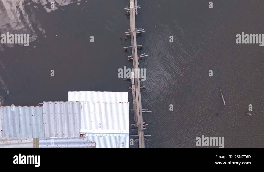 Drone view top down pan over densely packed squatted housing in Surigao ...