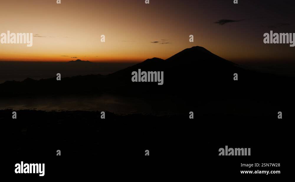 Mount Abang silhouette peak with red yellow glow from early dawn, scenic Stock Video Footage - Alamy