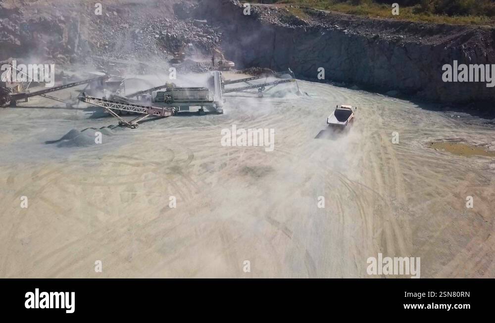 Empty dump truck approaches conveyor belts ready for a fresh load of ...