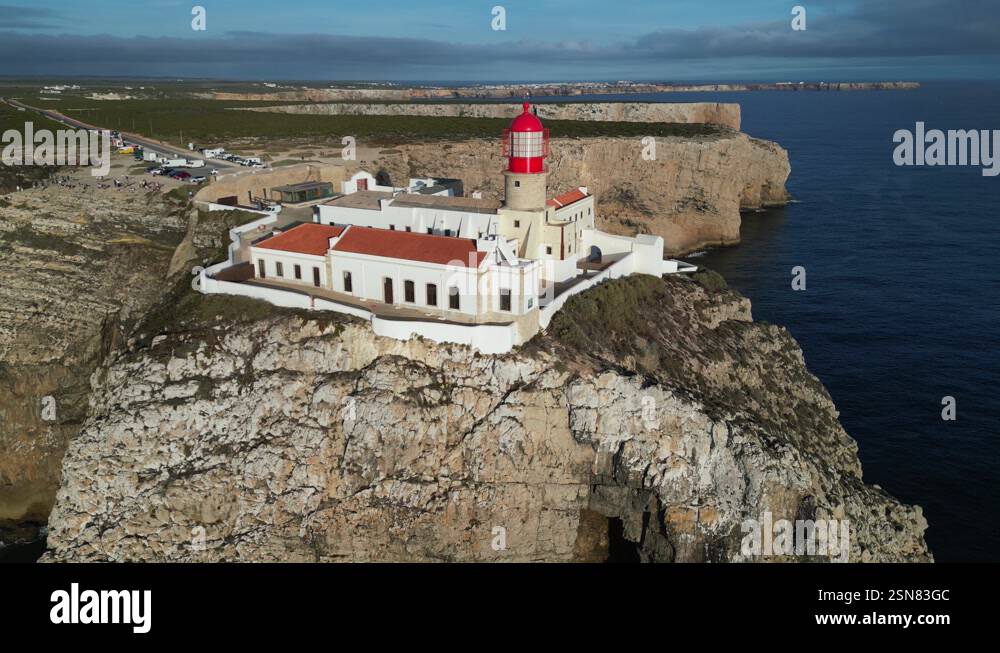 Golden hour low flight past St Vincent lighthouse atop ocean cliffs ...
