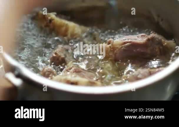 Boil soup with beef bones. Video of boiling meat to prepare as a food ...