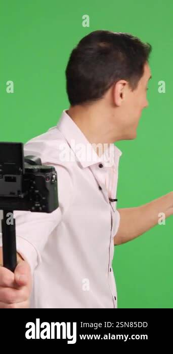 Enthusiastic content creator making various gestures while recording a ...