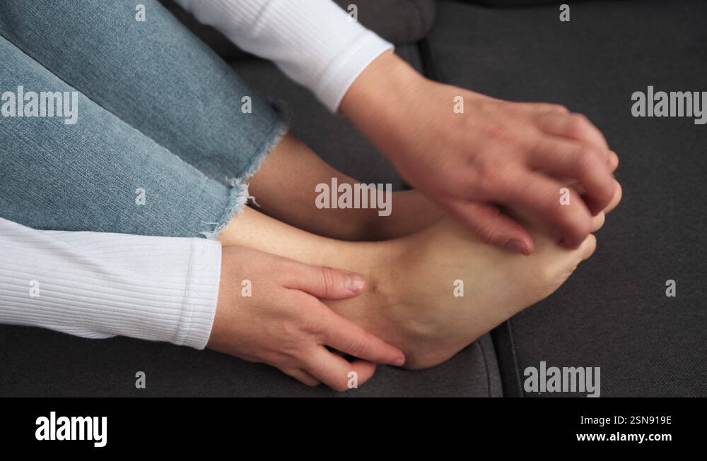 Foot pain concept. Ache young woman hand scratch feet, itch foot Stock ...