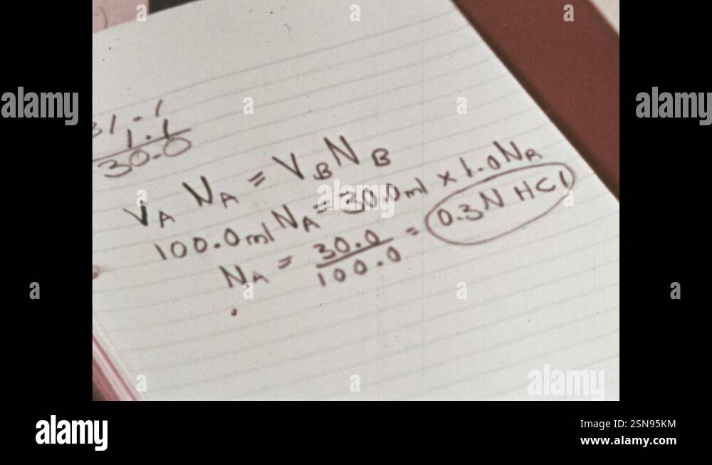 1960s: Equations in the notebook. Liquid drops slowly falling from a ...