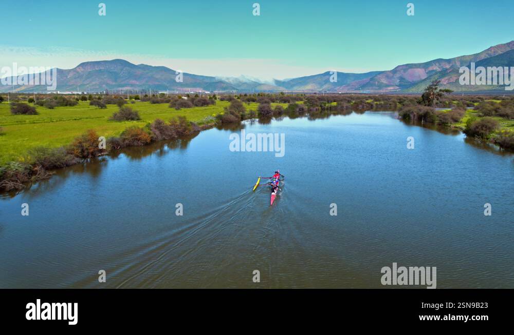 Tracking flyover of a rowing team practicing in a boat on the Caren ...