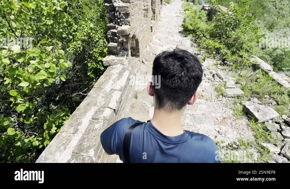 From a top-down view, a man carefully descends the convoluted stairs ...