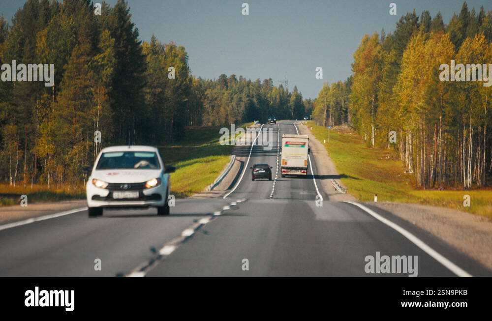 Asphalt road with cars. Camera moves along the road with moving cars ...