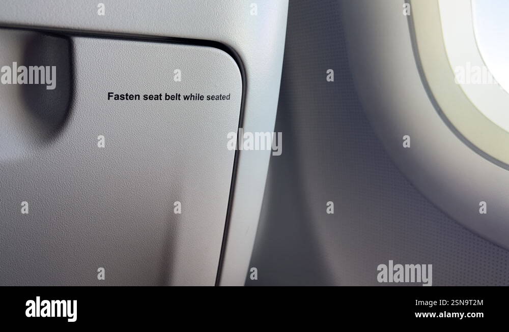 Fasten seat belt while seated shown on back of airplane chair 4k Stock ...