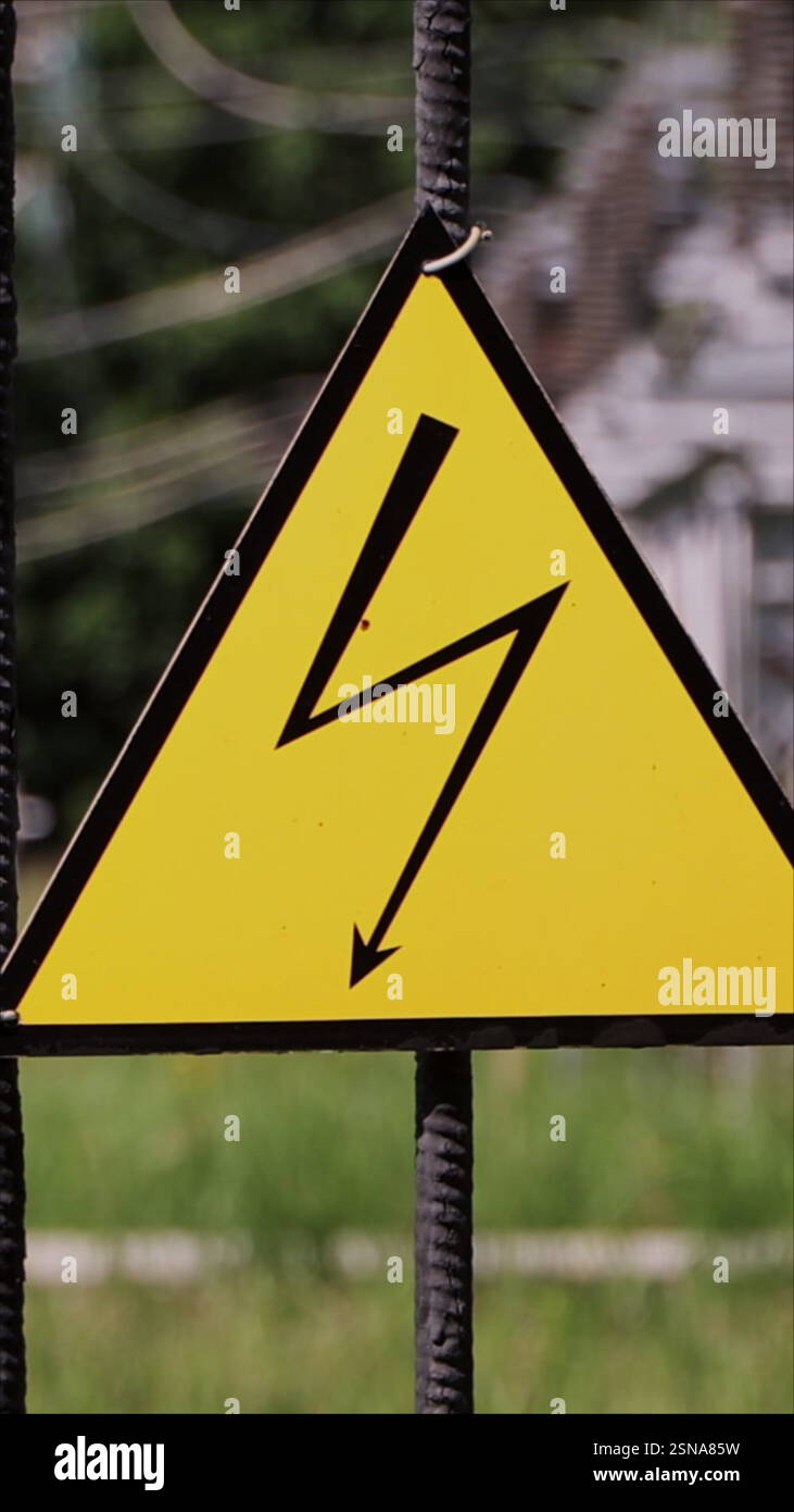 High Voltage Warning Sign On Fence At Electrical Substation. Vertical ...