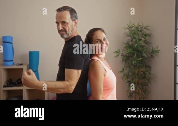 Middle-aged hispanic man and woman expressing love and strength at a ...