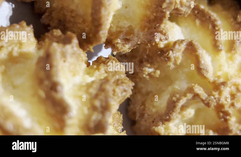 Golden crispy pastries with flaky layers captured up close for a ...