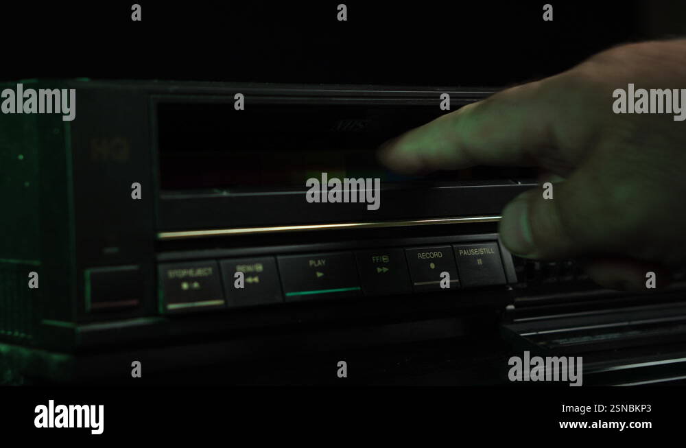 Inserting VHS Video Cassette in VCR and Pressing Play Button, Close Up ...
