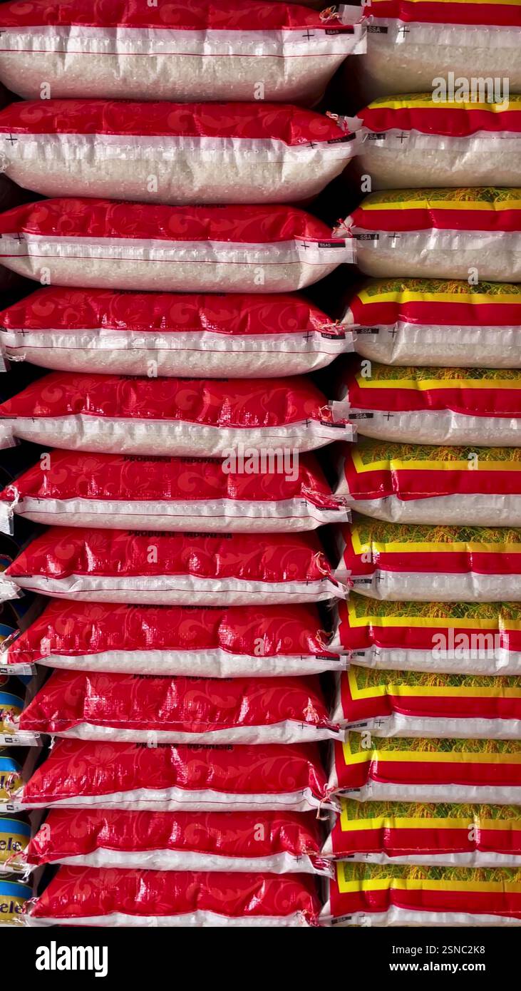 Piles of packaged rice of various brands and types at a rice trader's ...