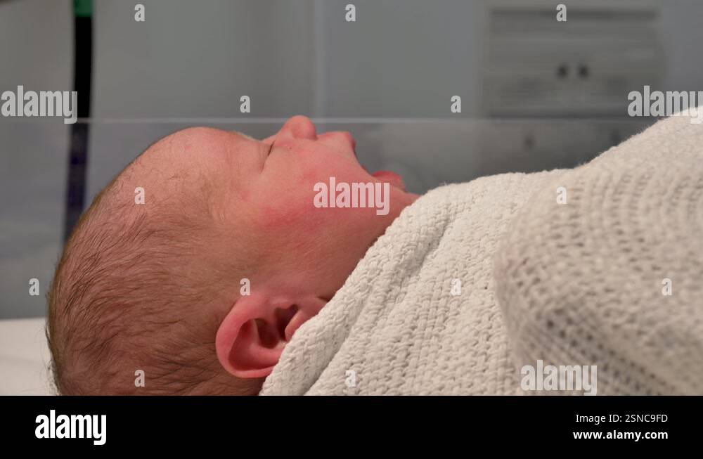 Newborn baby gasping for air with traces of amniotic fluid in her mouth ...