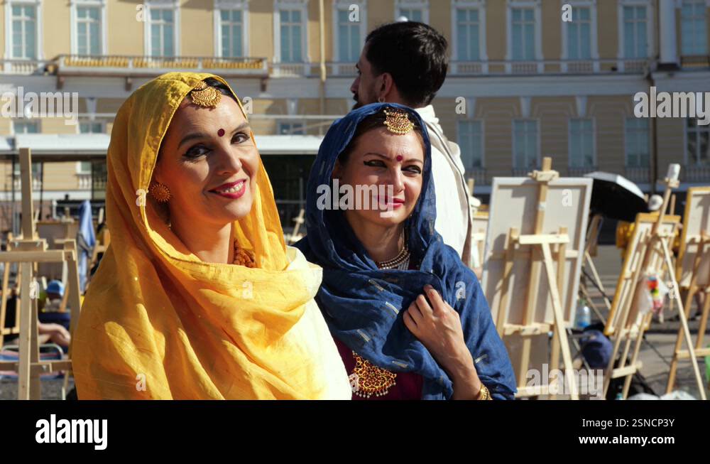 Two women in Indian saree with bindi points on forehead posing and ...