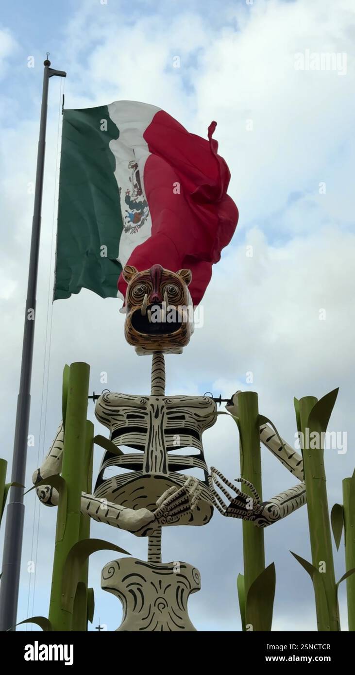 Giant skeleton in Zocalo of CDMX. Mexican flag behind waving. Day of ...