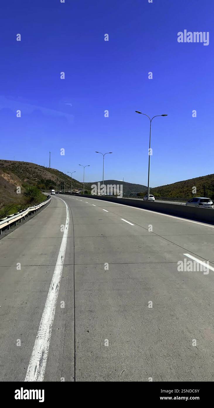 Vertical 4K video. View from car window of mountain, highway, lantern ...