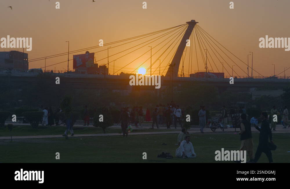 People at Iqbal Park with Azadi Chowk Interchange at Sunset in Lahore, Pakistan Stock Video ...