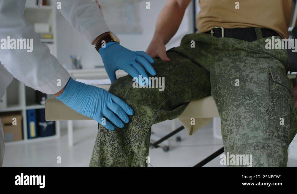 Unrecognizable Doctor Examining and Carefully Lifting Broken Leg of ...