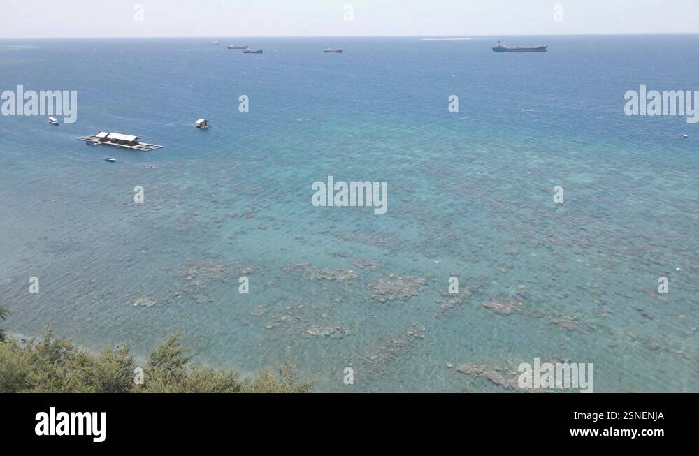Drone footage captures the stunning blue waters of Bali Strait, where ...