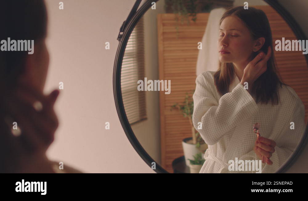 Mirror Reflection of Young Girl in Robe Massaging Face with Quartz Roller Stock Video Footage ...