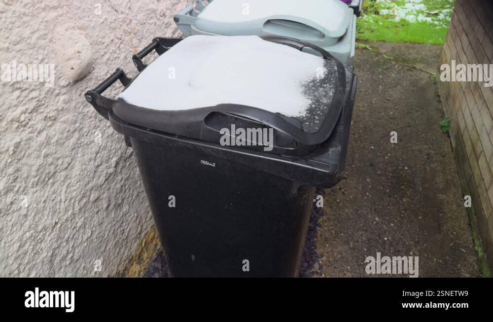 Wheelie bins for waste, trash and recycling, with their lids covered in ...