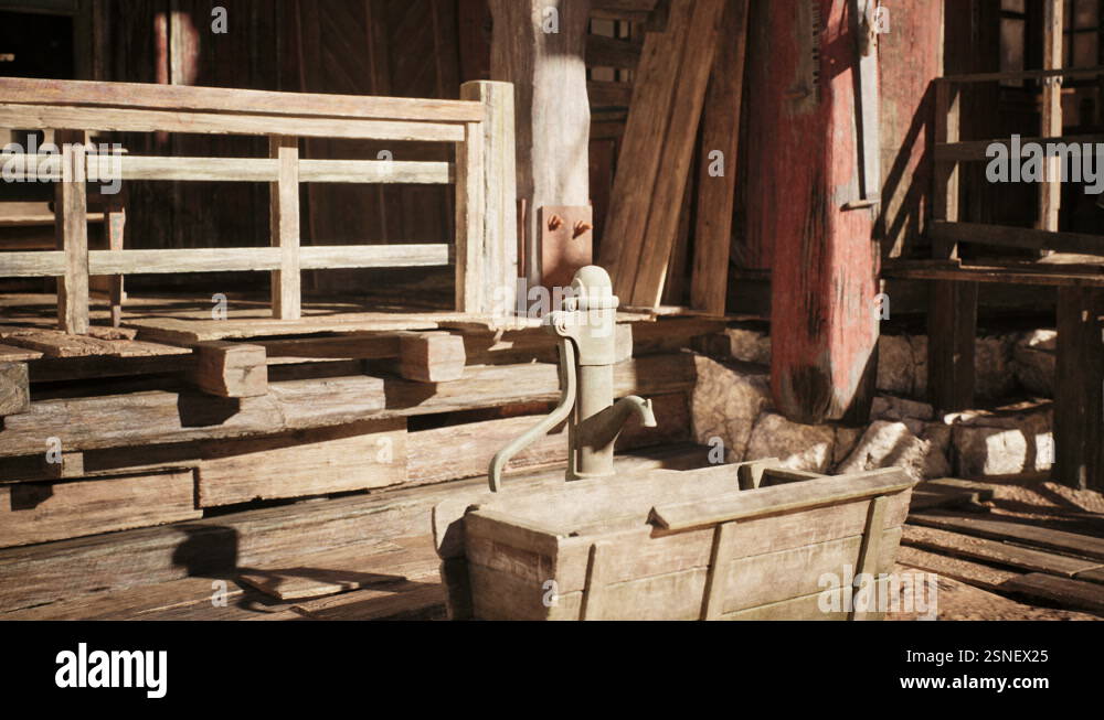 Rustic water pump near wooden structures in an old village setting ...