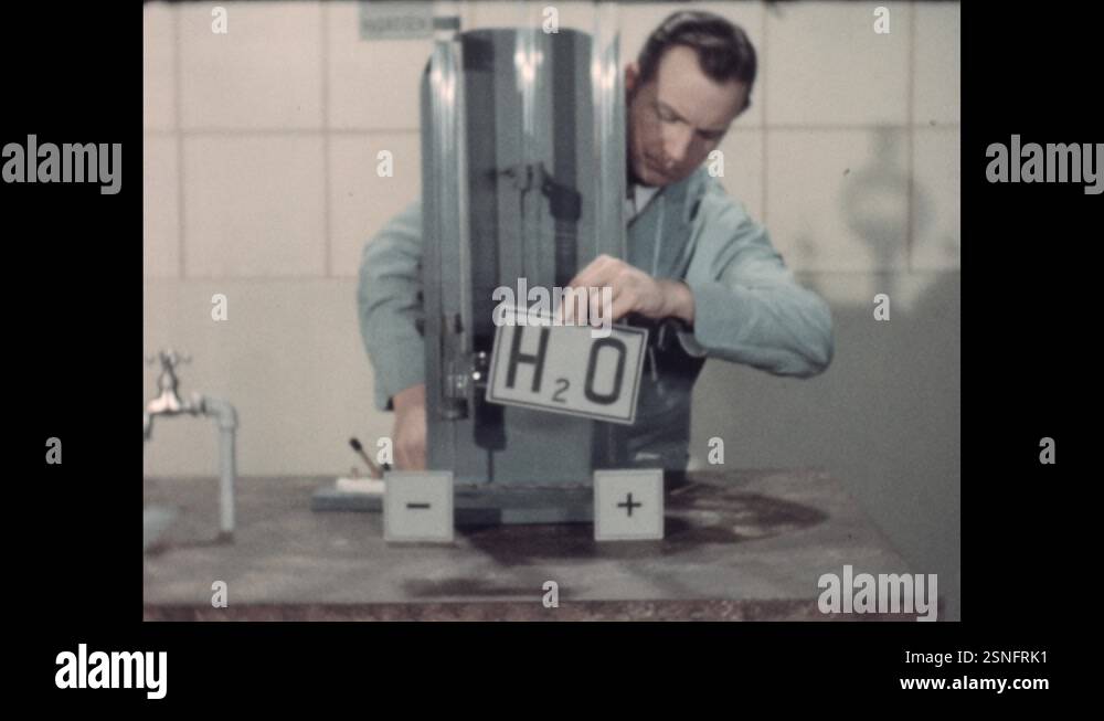 1950s: Man removes sign from front of lab equipment, points to labels ...