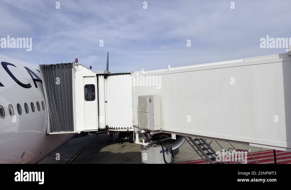 Canadian Airplane Docked at Airport Terminal with Jet Bridge Attaching ...