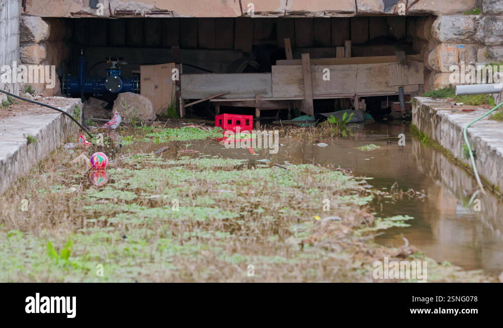 Sewage in abandoned concrete pond, mud on the surface of a garbage ...