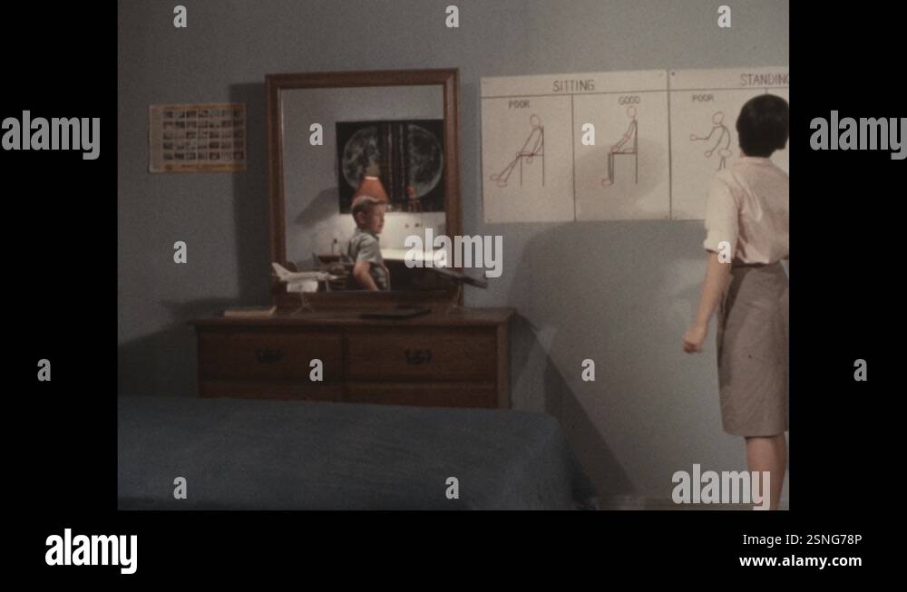 1950s: Girl stands before posters depicting posture and speaks to boy ...