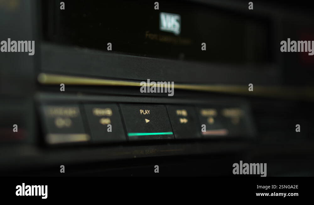 Inserting VHS Video Cassette Tape and Pressing Play Button on VCR ...