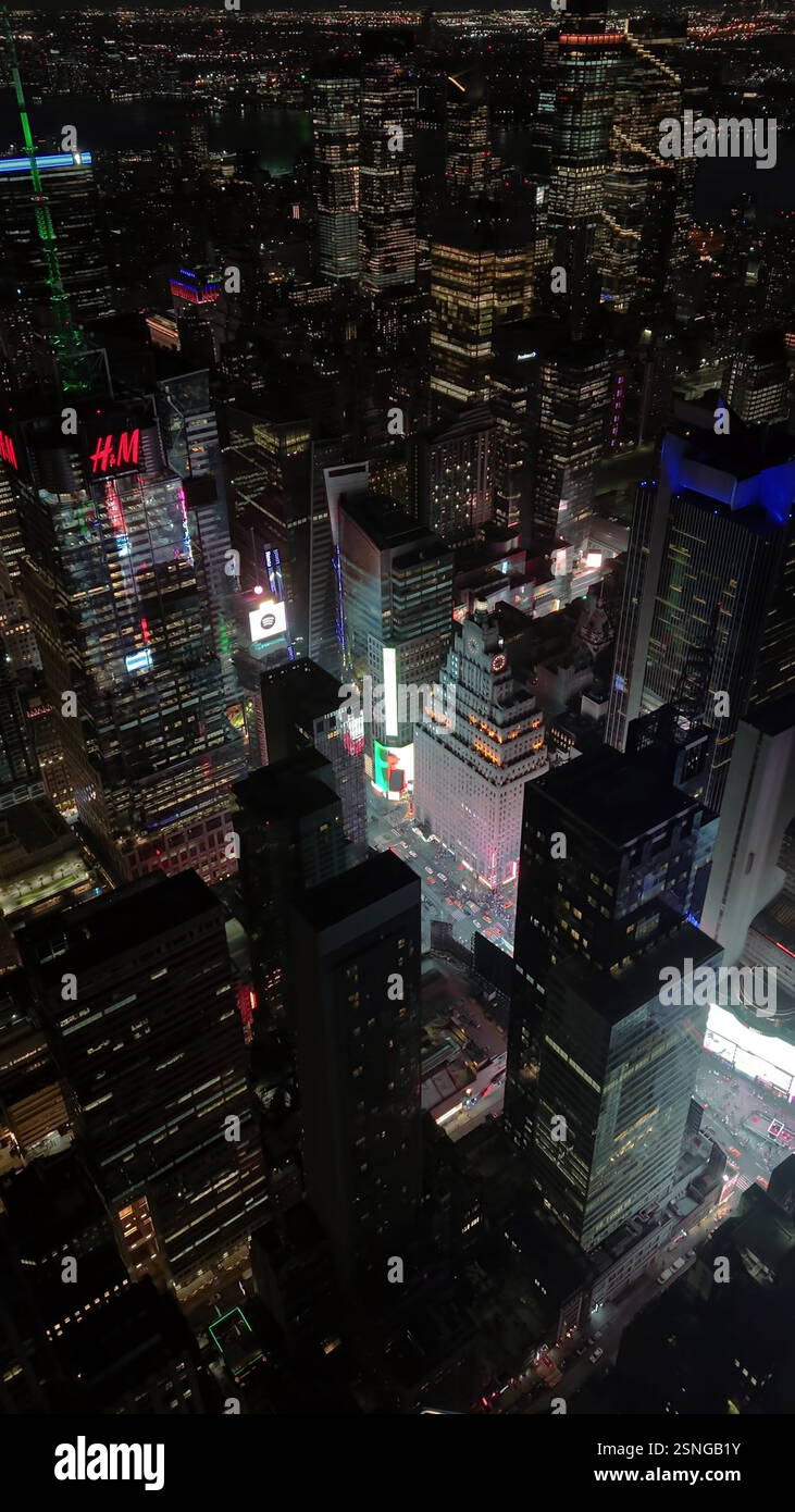 Vertical drone shot around the illuminated Times square, night-time in ...