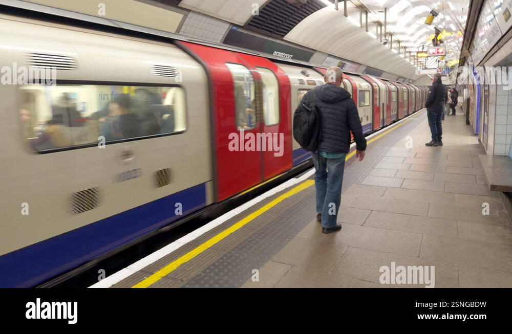 A passenger tube train arriving in an underground station, London Stock ...