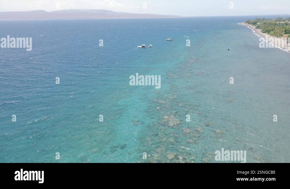 Drone footage captures the stunning blue waters of Bali Strait, where ...
