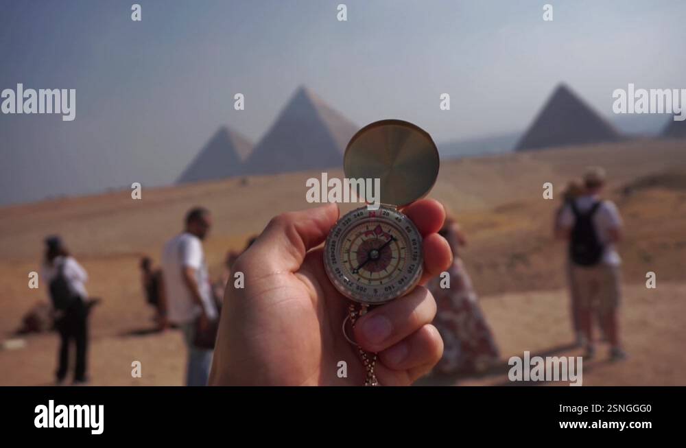 White Hand opening a vintage compass in front of the Giza pyramids in Cairo Stock Video Footage ...