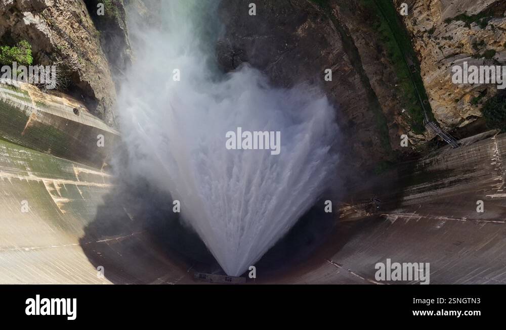 Water discharge from a dam inside a mountain canyon. Pressurized water ...