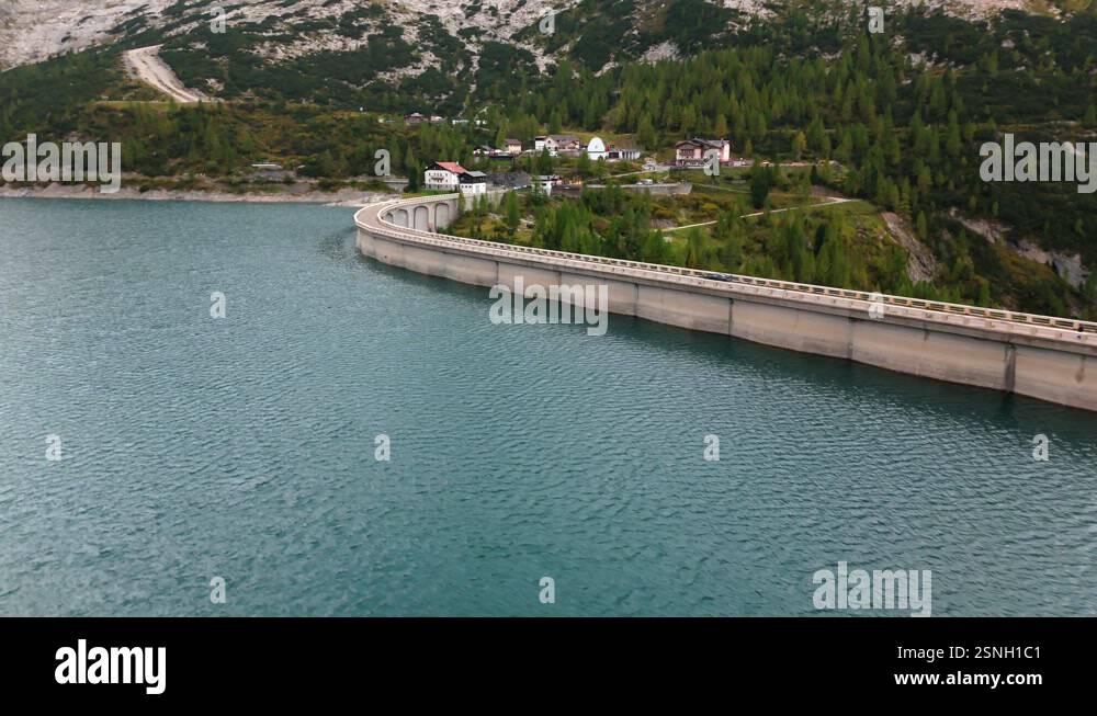 Lago di Fedaia Dam with Alpine Village and Marmolada in the Dolomites ...