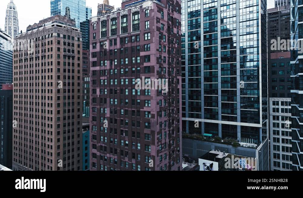 Low-altitude aerial of Chicago City Towers with streets and river below ...