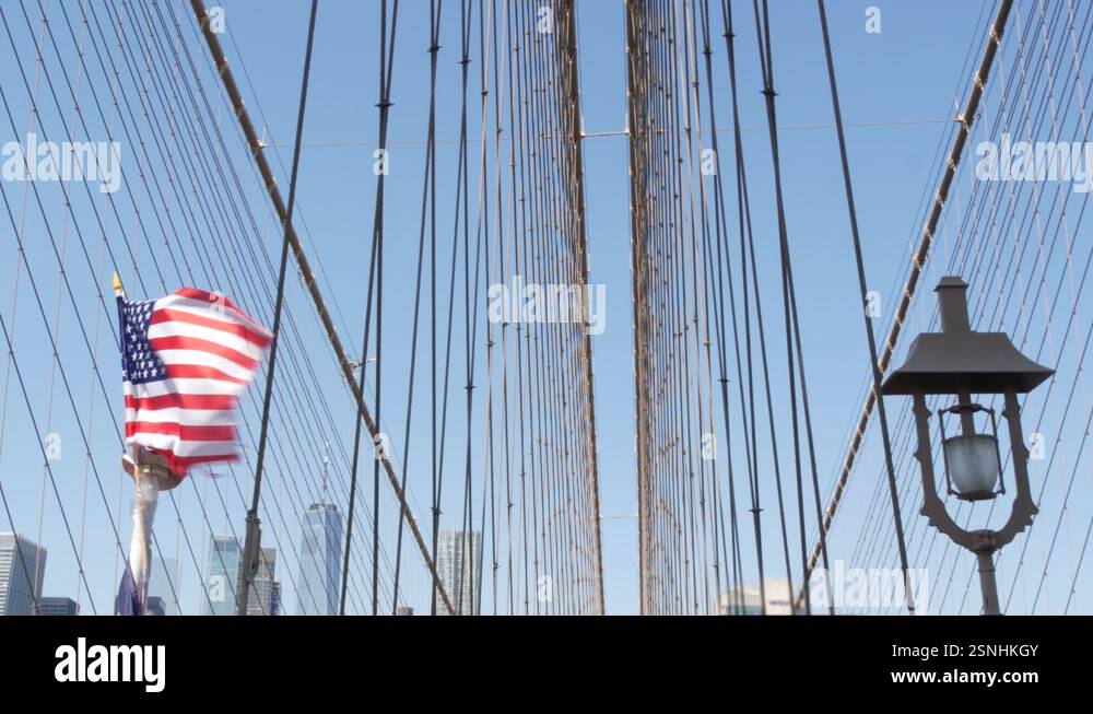 American flag on Brooklyn Bridge to Manhattan, New York City. Patriotic ...