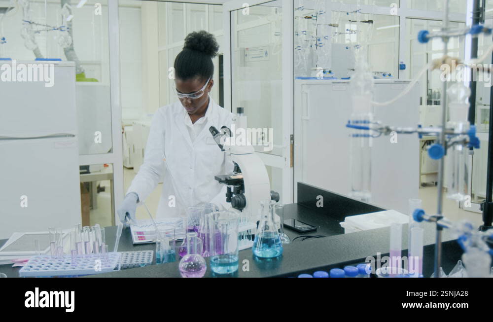 Female biologist using microscope writing Stock Videos & Footage - HD ...