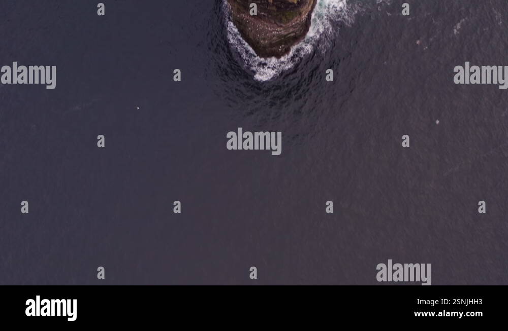 Drone Tracking Top-Down Over Dun Briste Sea Stack with Waves Crashing ...