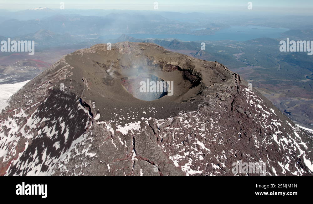 A breathtaking view from the summit of a volcano reveals a large crater ...