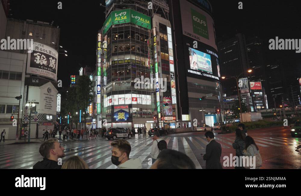 Nighttime shots of Shibuya Tokyo reveals vibrant neon lights, bustling crowds Stock Video ...