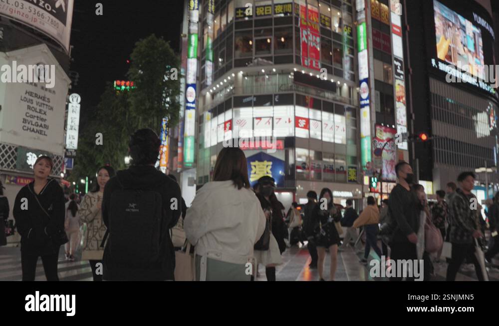 Nighttime shots of Shibuya Tokyo reveals vibrant neon lights, bustling crowds Stock Video ...