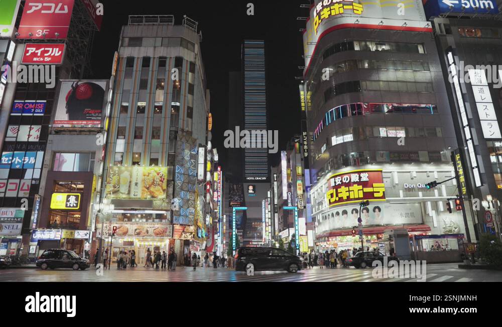 Nighttime shots of Shibuya Tokyo reveals vibrant neon lights, bustling crowds Stock Video ...