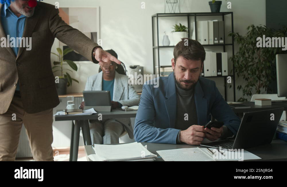 Angry Boss in Clown Wig and Nose Yelling at Employees during Office ...